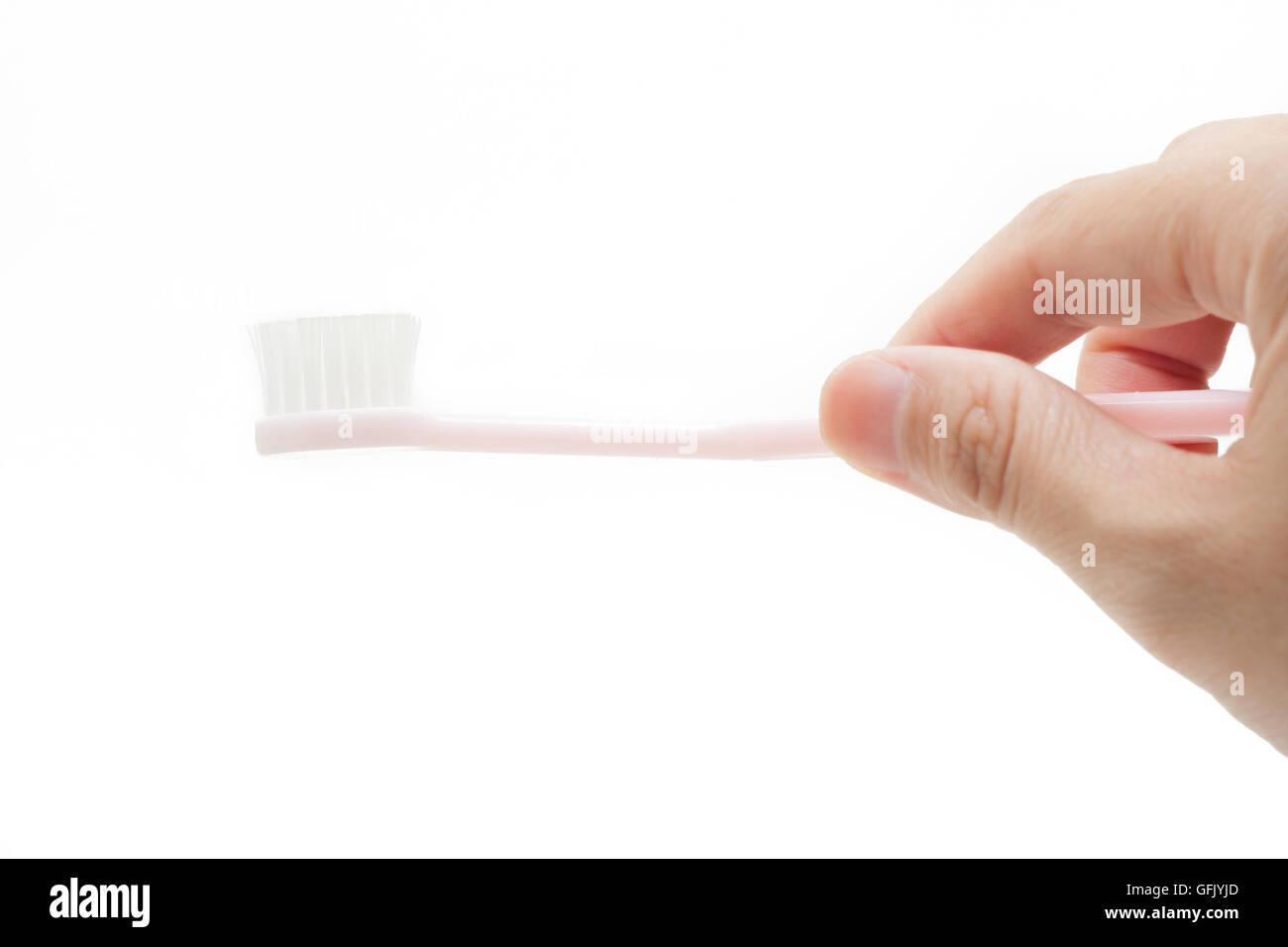 Holding a toothbrush by hand on white isolated background Stock Photo ...