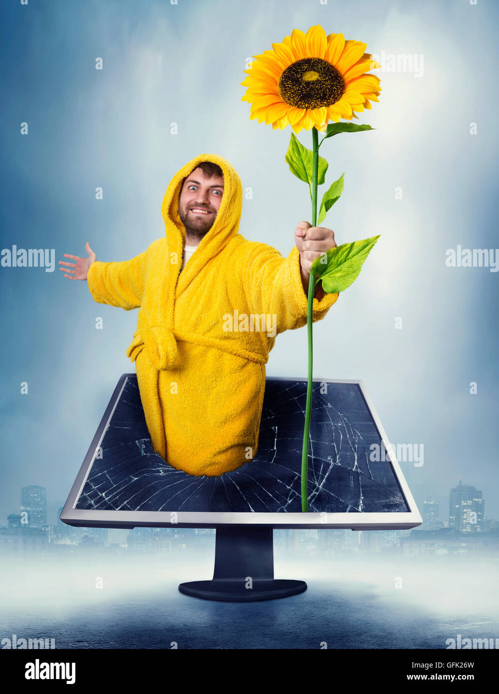 Man in the monitor holding sunflower Stock Photo - Alamy