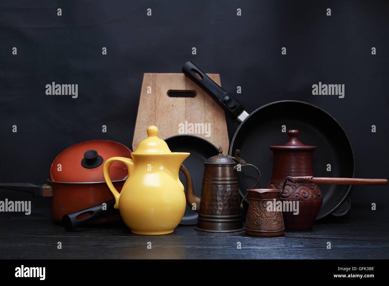 Set of various kitchen dishes on dark background Stock Photo - Alamy
