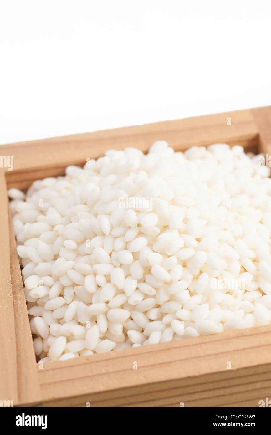 Sticky rice in Japanese sake cup called Masu on white isolated ...