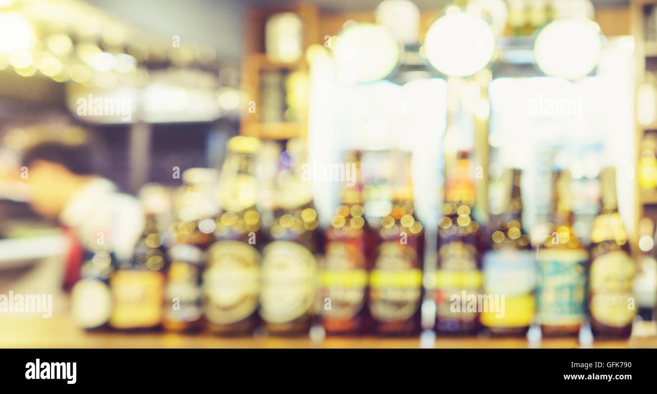Blur pub bar with beer bottles background Stock Photo - Alamy