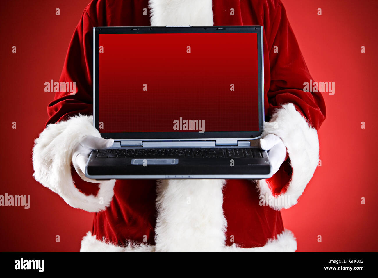 Anonymous Santa Claus on a red background holding various props, gifts ...