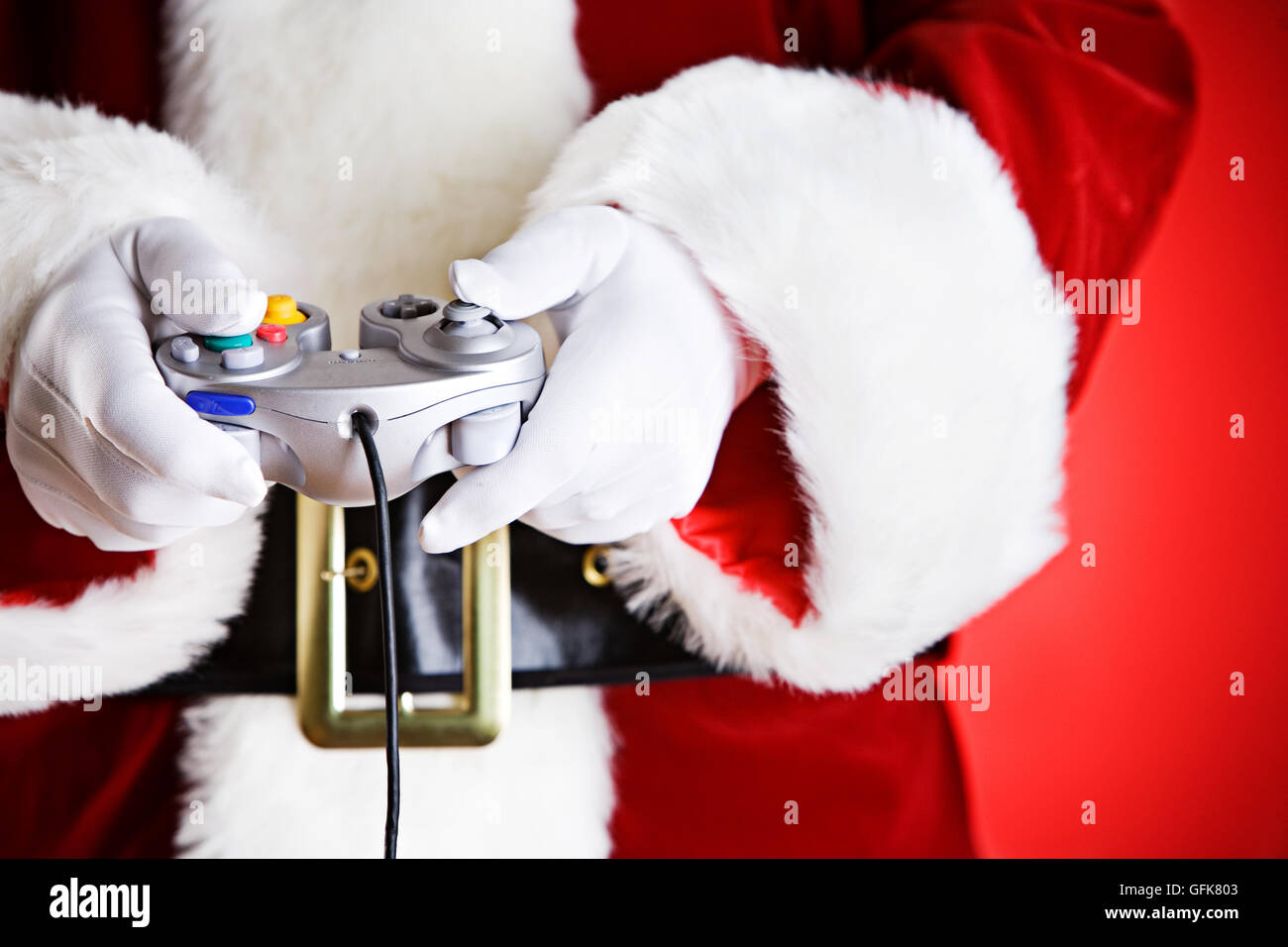 Anonymous Santa Claus on a red background holding various props, gifts ...