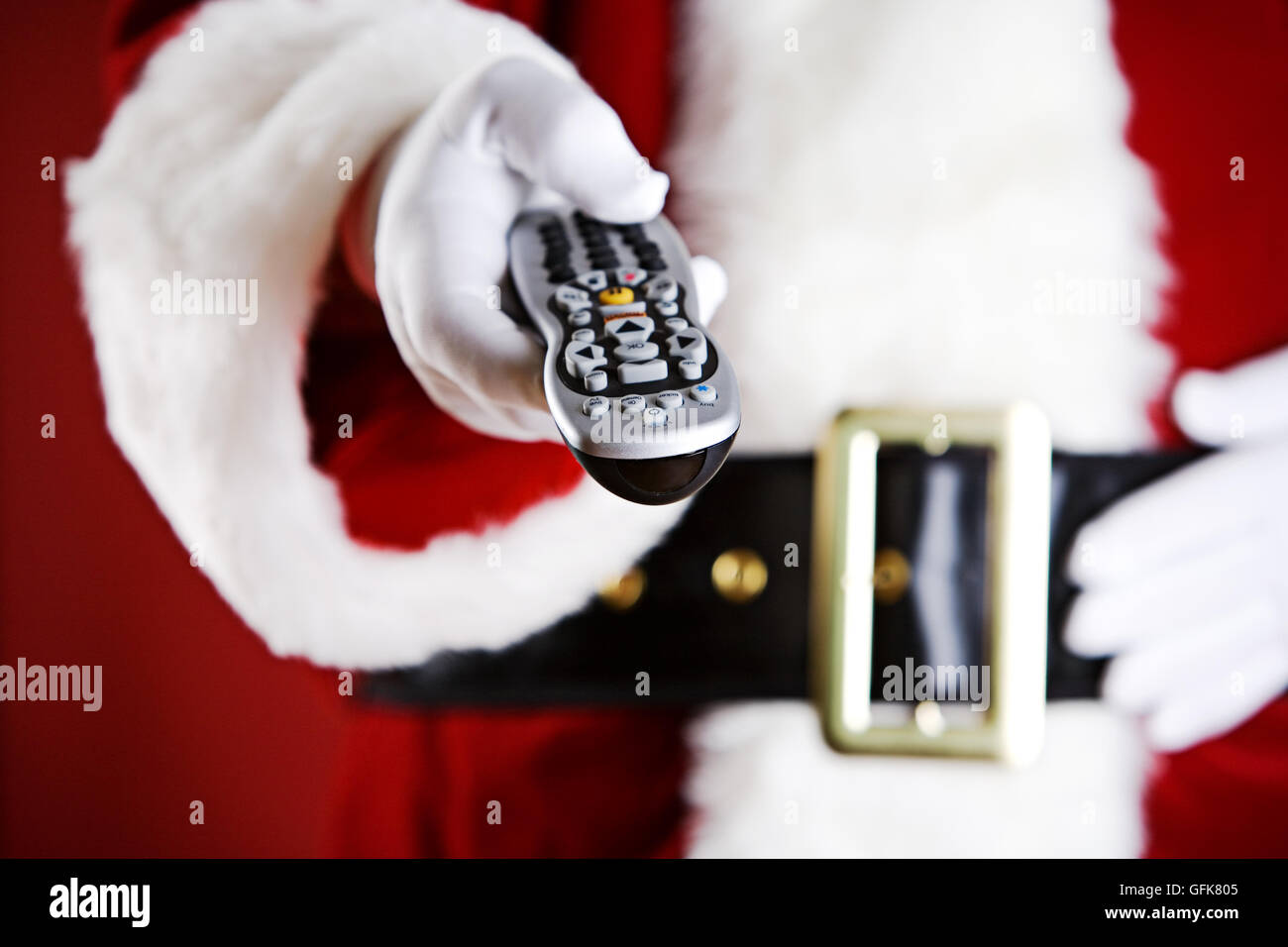Anonymous Santa Claus on a red background holding various props, gifts ...