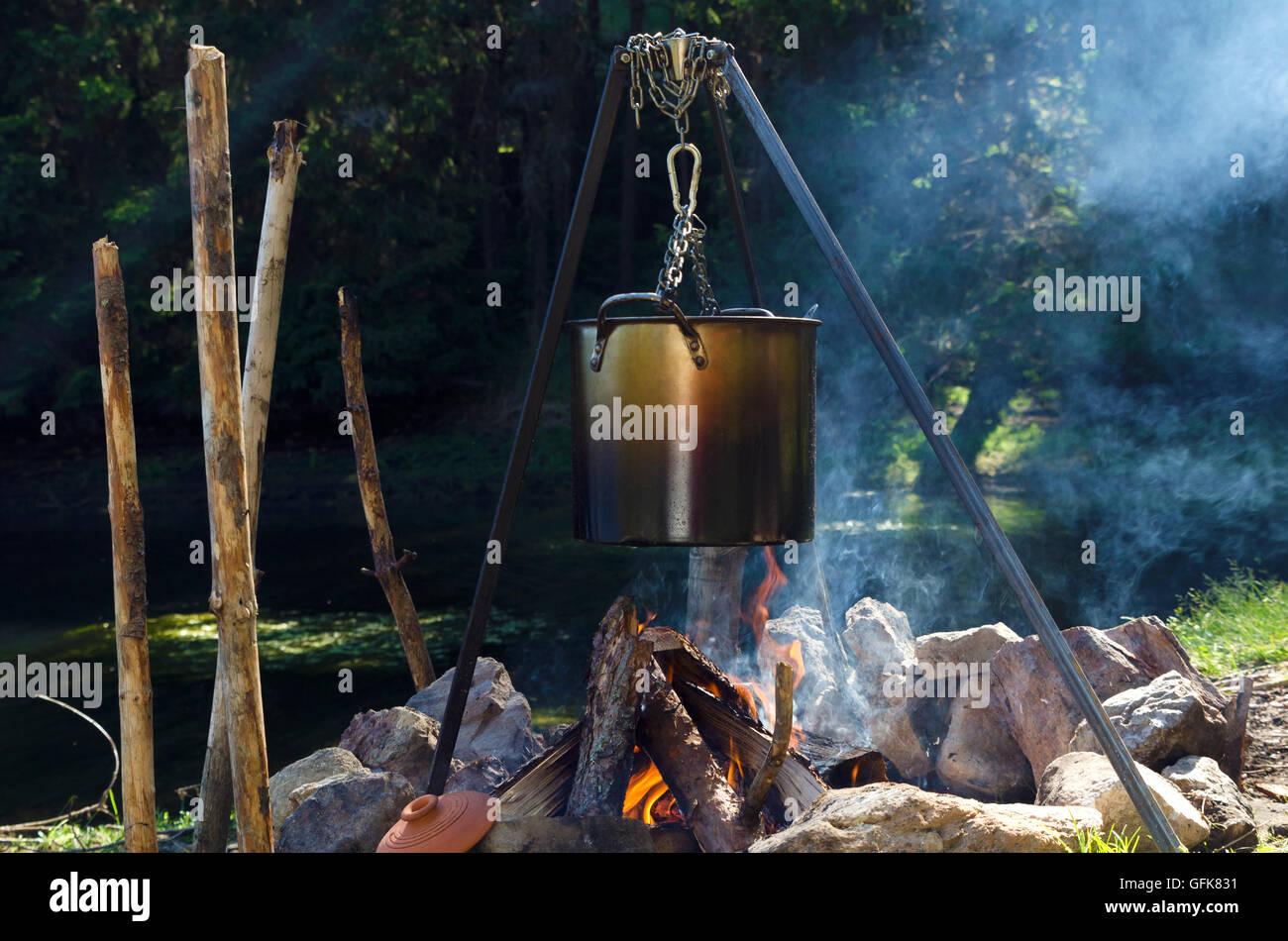 Camping in a forest and campfire Stock Photo - Alamy