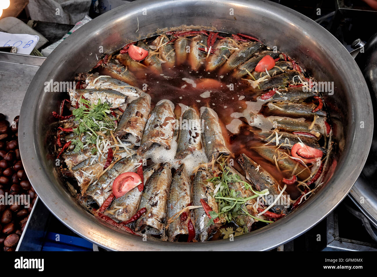 Selection of boiled fish cooking on a Thai street food stall. Thailand ...
