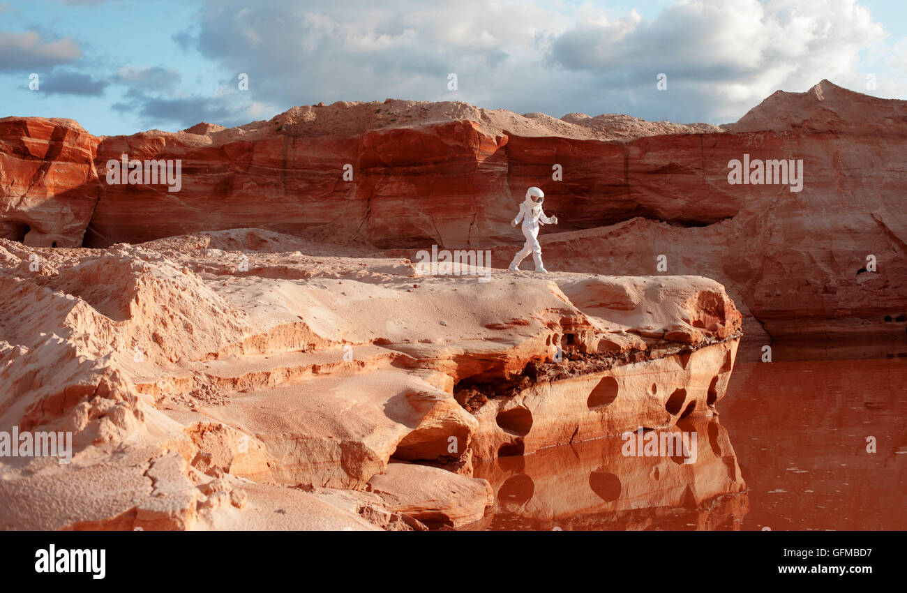 futuristic astronaut on another planet, sandy red planet Stock Photo ...