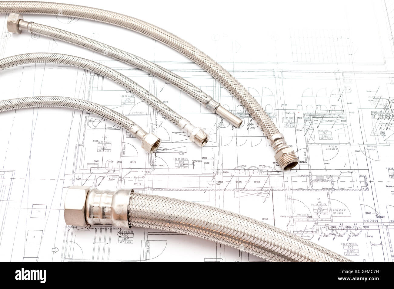 on an house plan lie several hoses Stock Photo - Alamy