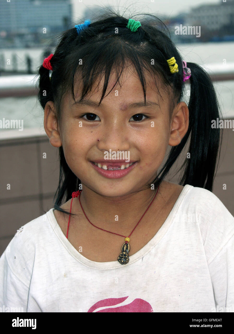 Young girl playing near the Huángpu River in the Pudong New Area of ...