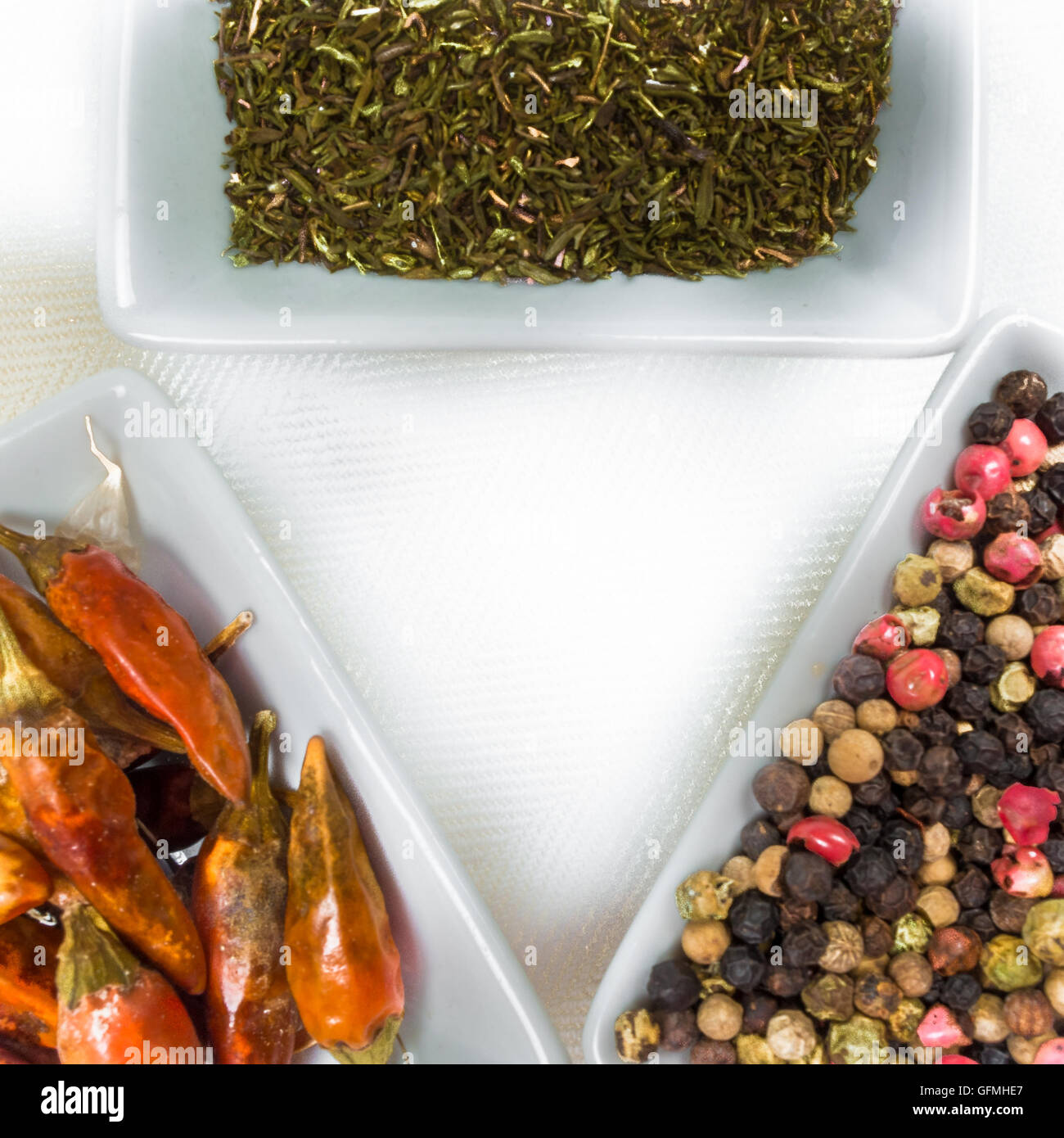 various spices in white bowls of square shape in white background Stock ...