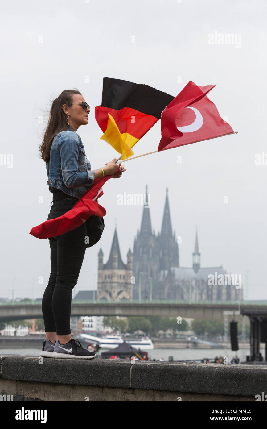 Cologne, Germany. 31st July, 2016. A young woman flies the German and ...