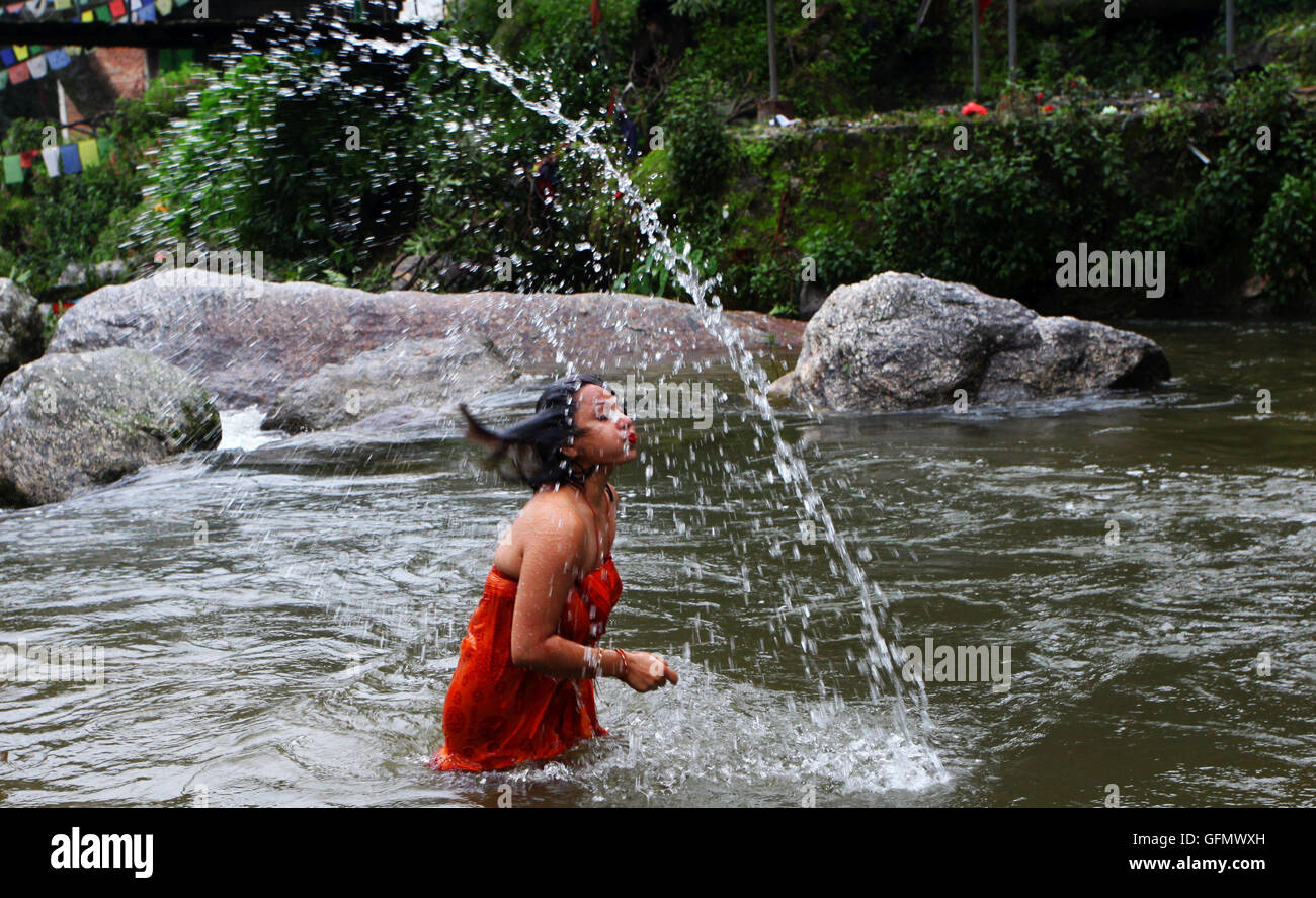 Kathmandu, Nepal. 1st Aug, 2016. A Nepalese woman takes a holy bath ...
