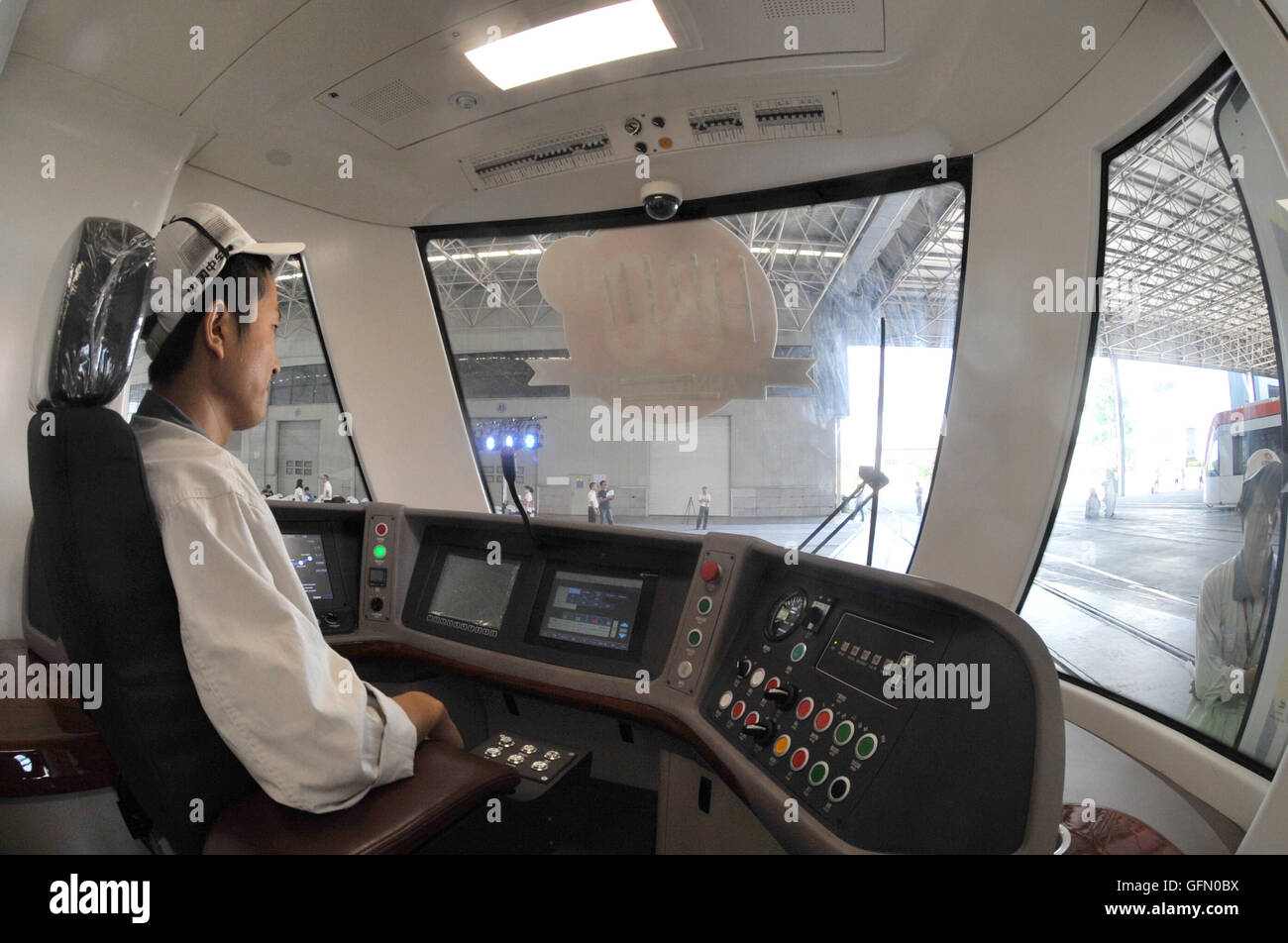 Changsha, China. 1st Aug, 2016. A man sits in the cab of China's first ...