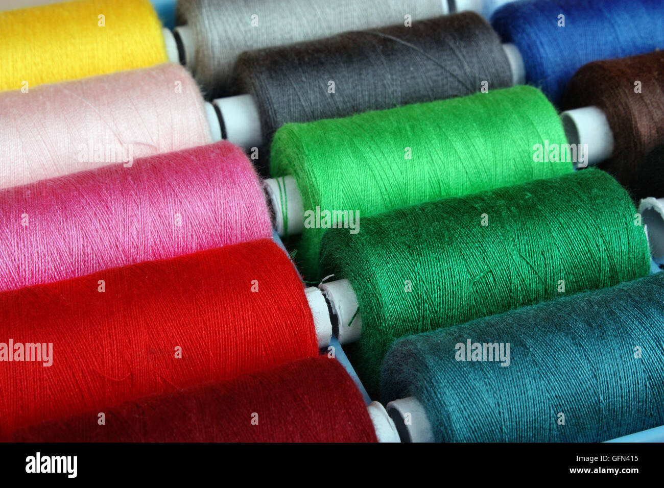 Colorful reels of threads background Stock Photo - Alamy