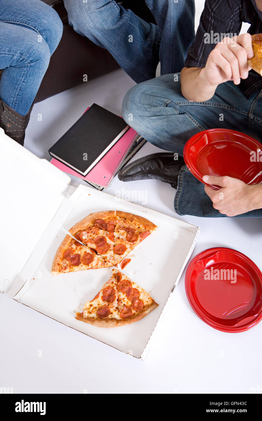 Group of friends, hanging out, eating pizza and studying Stock Photo ...