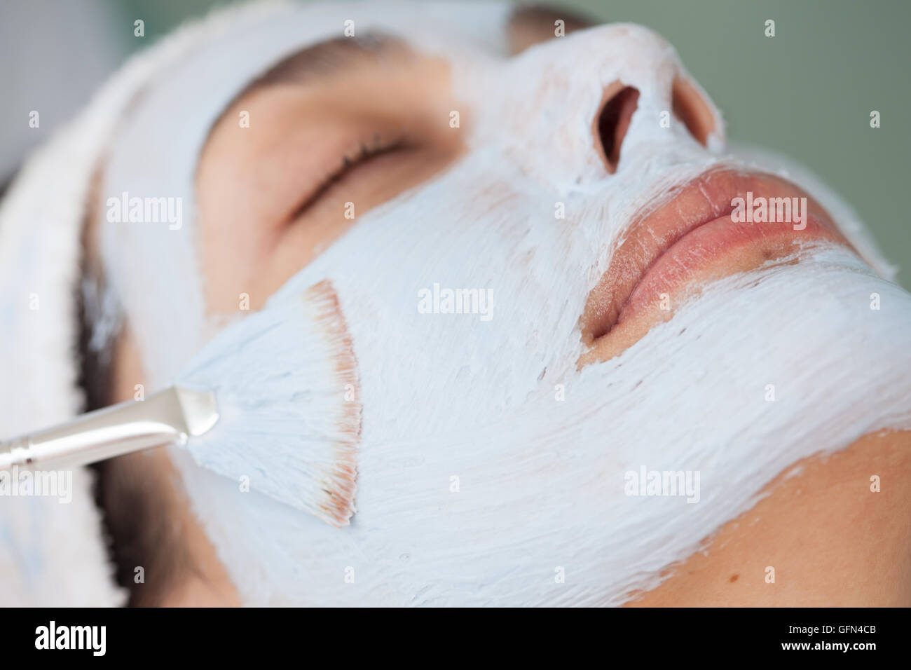 Facial mask application on young female patient Stock Photo - Alamy