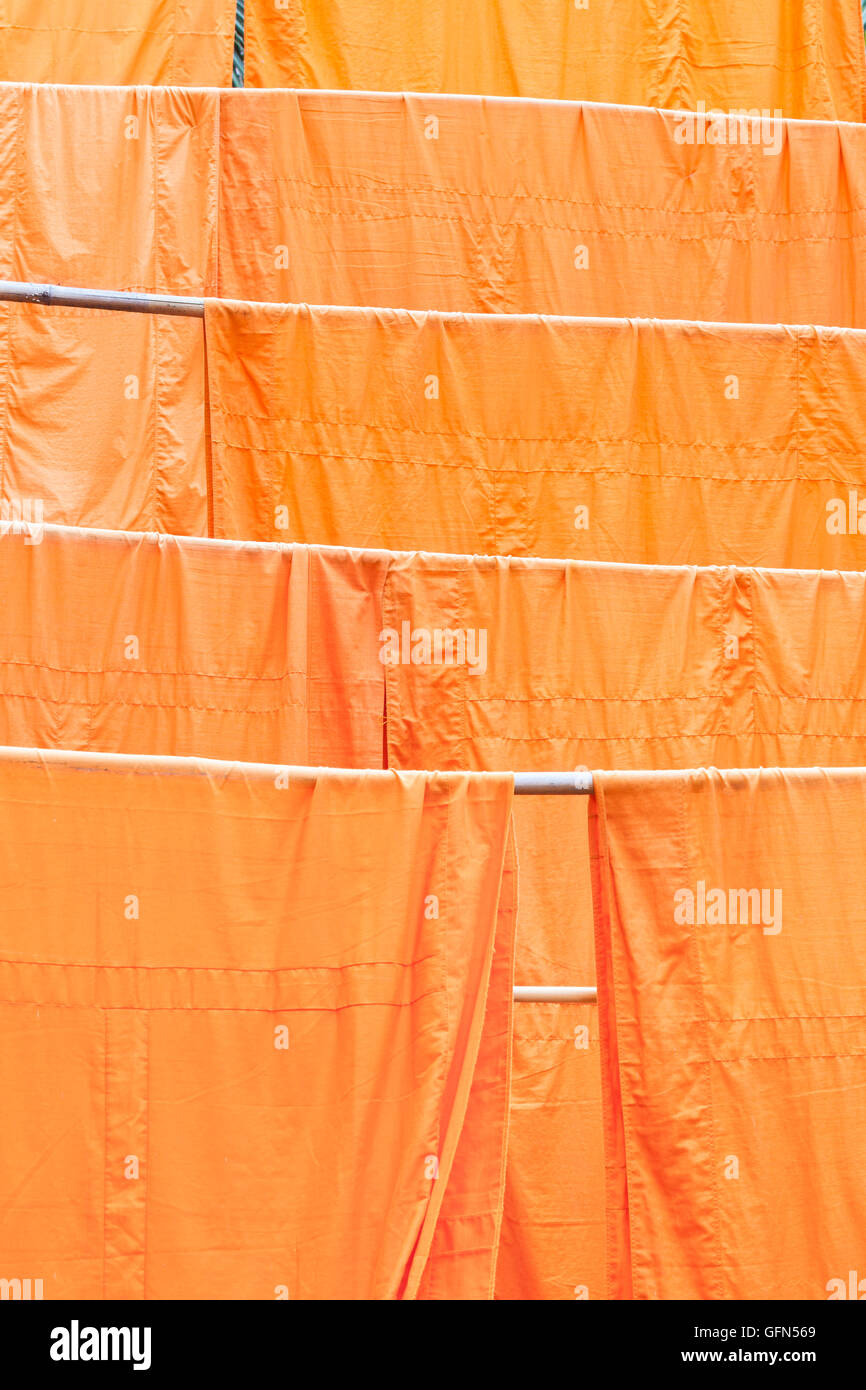 Robes of buddhist monks hanging out to dry at a temple in Thailand ...