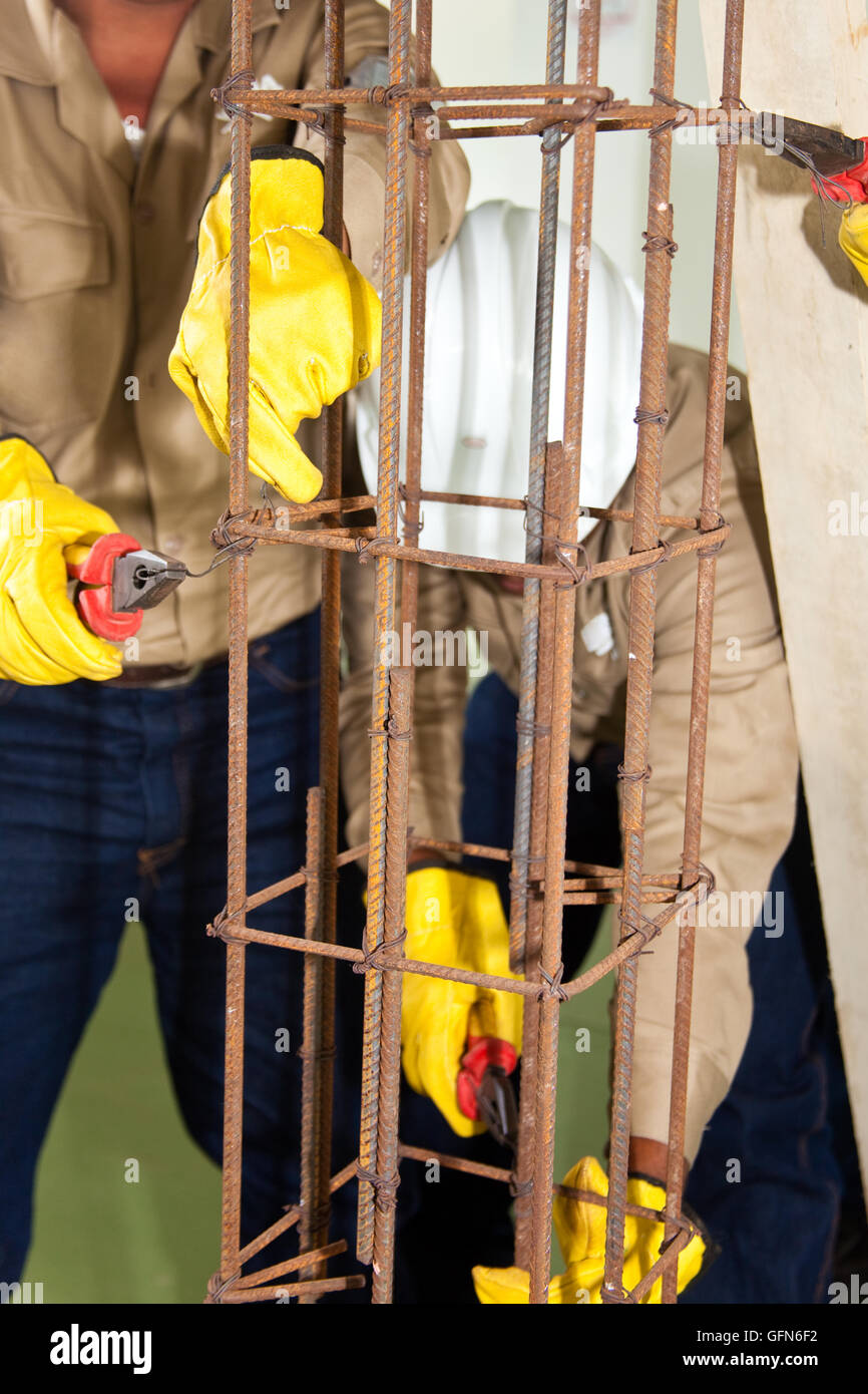 Group of men learning how to make an iron framework Stock Photo - Alamy