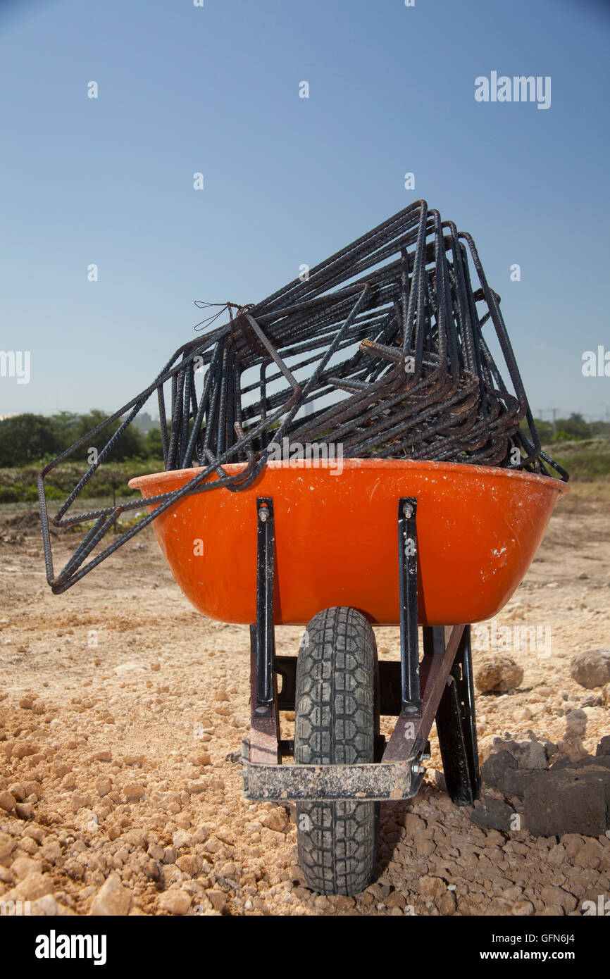 Wheelbarrow with iron at a construction field Stock Photo - Alamy