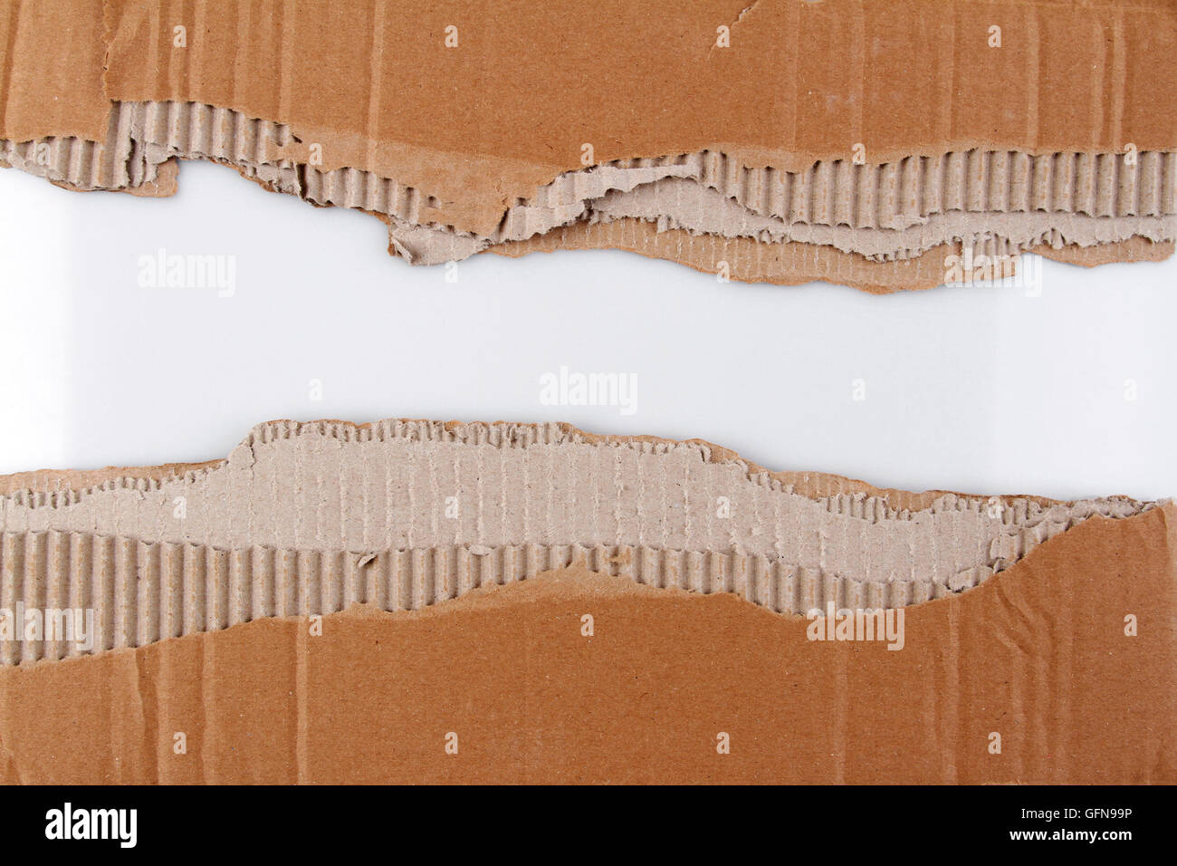 Hole ripped in corrugated cardboard Stock Photo - Alamy