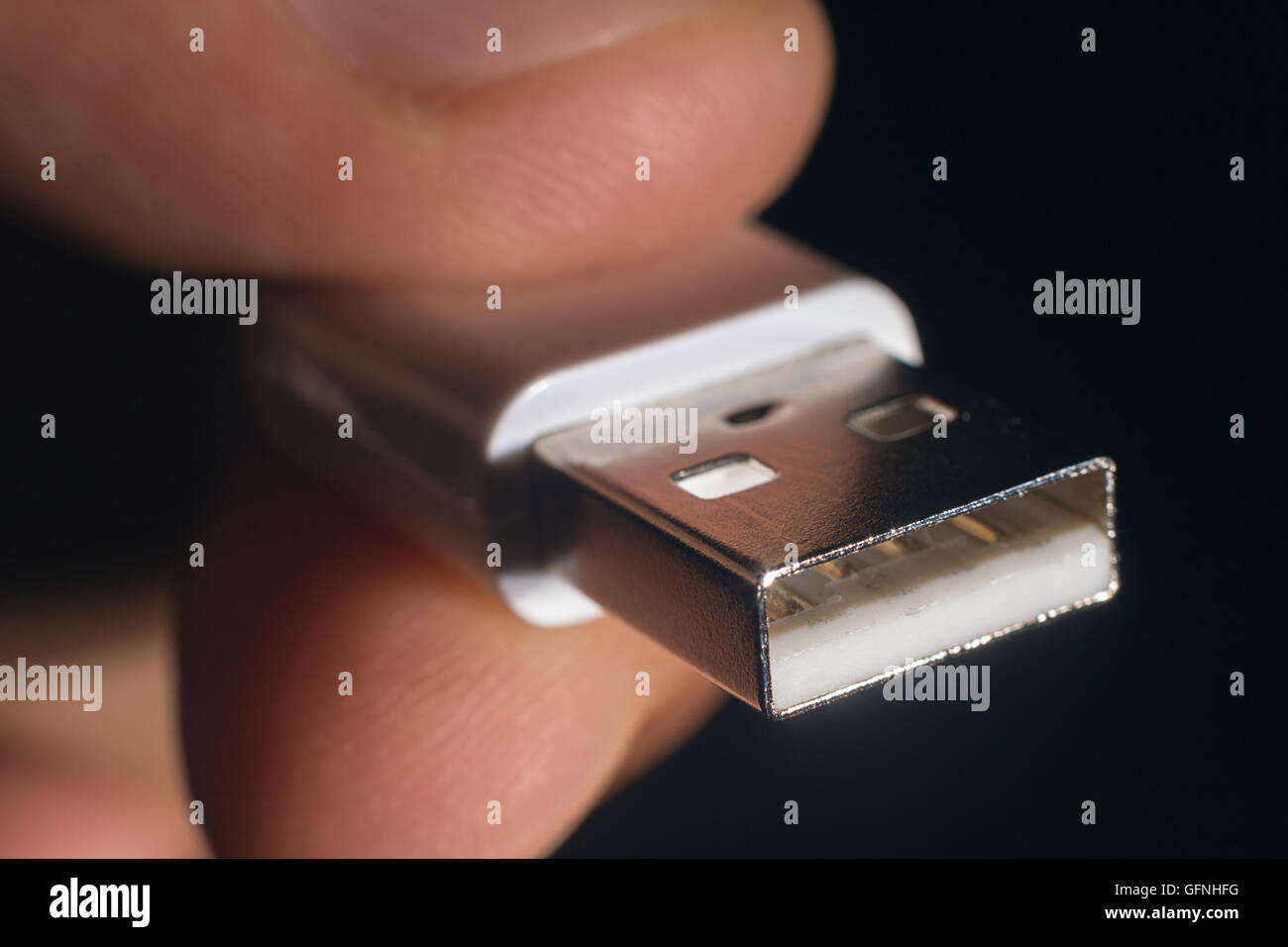 Hand holding white USB cable. Man's hand holds a USB Connector. Closeup ...