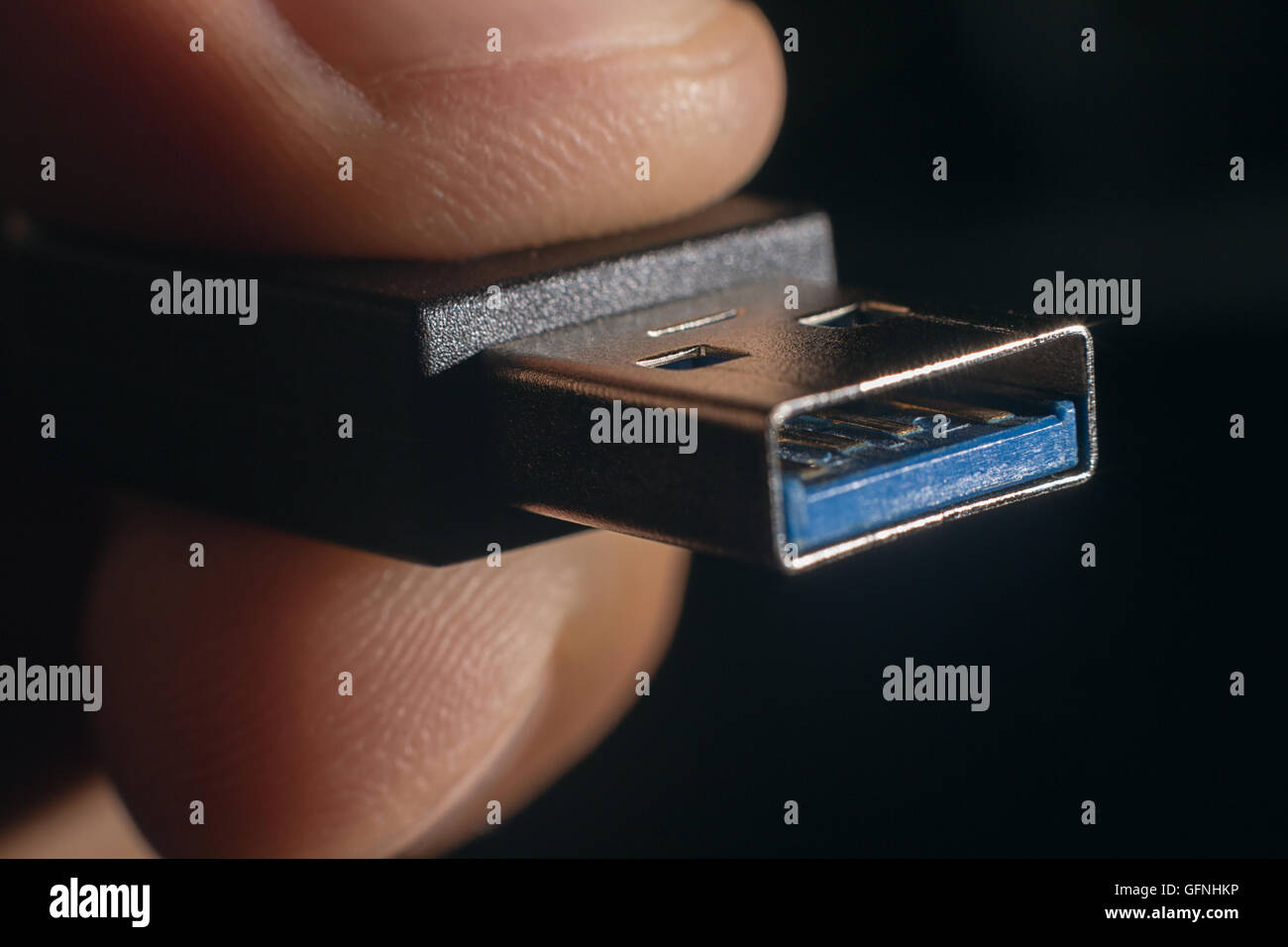 Hand holding black USB cable. Man's hand holds a USB Connector. Closeup ...