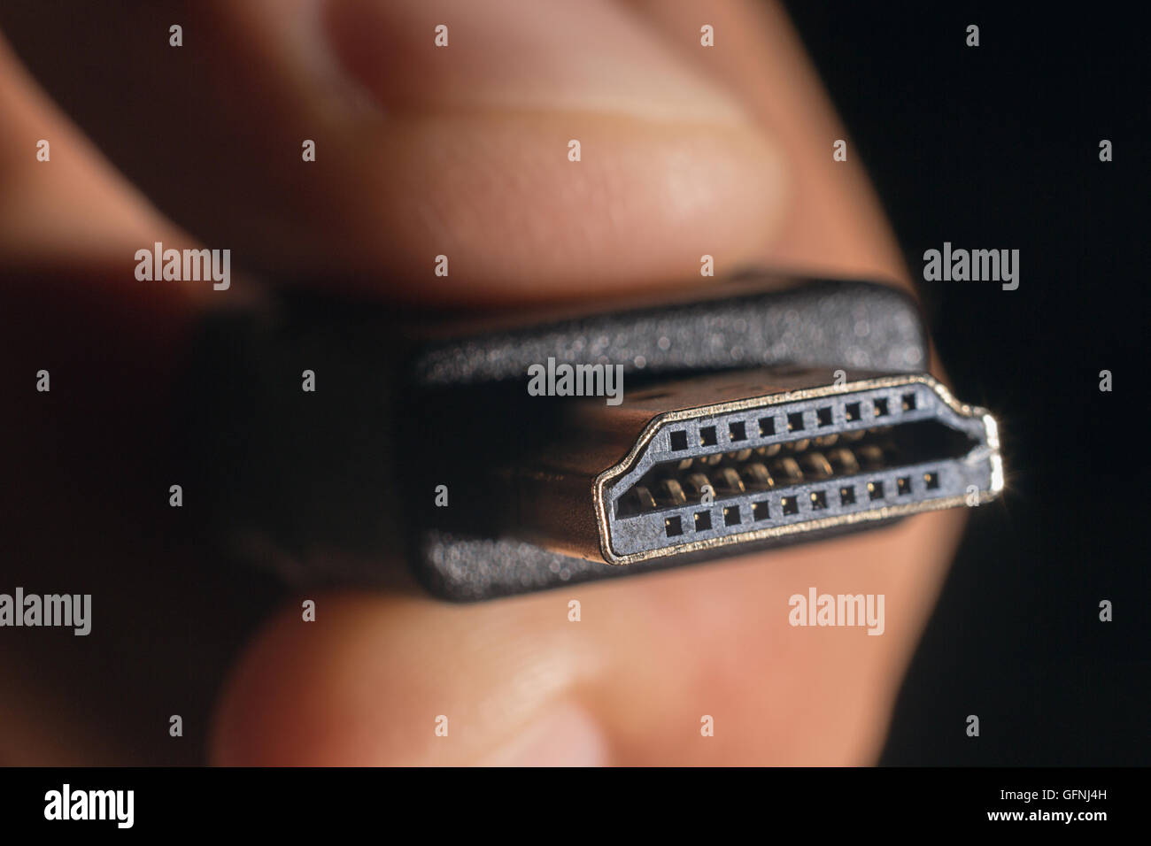 Hand holding black HDMI cable. Man's hand holds a HDMI Connector ...