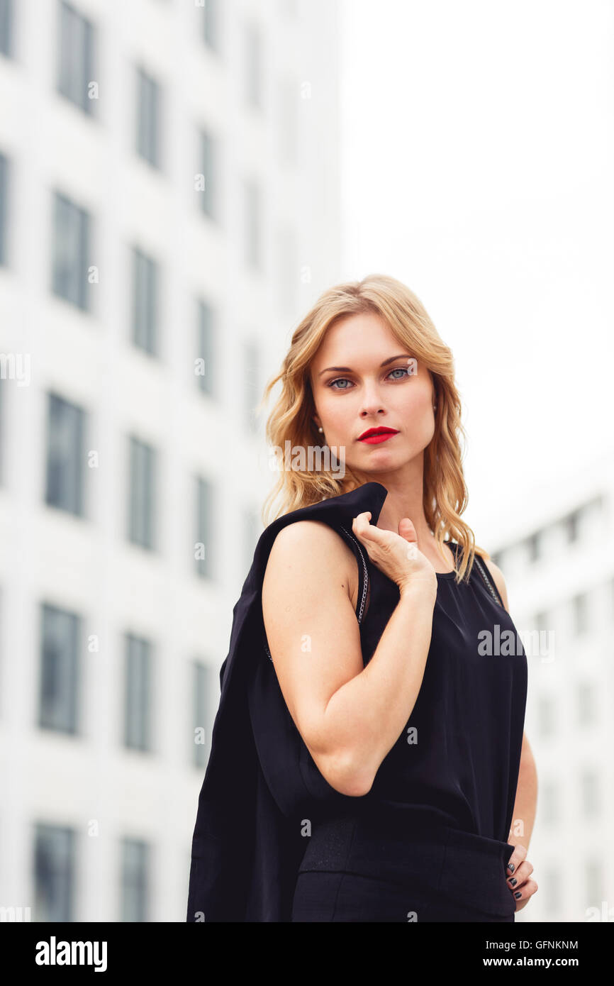 Portrait of beautiful independent woman stands proudly in modern area ...