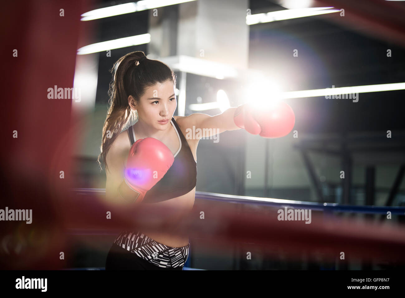 Female Chinese boxer practicing in boxing ring Stock Photo - Alamy