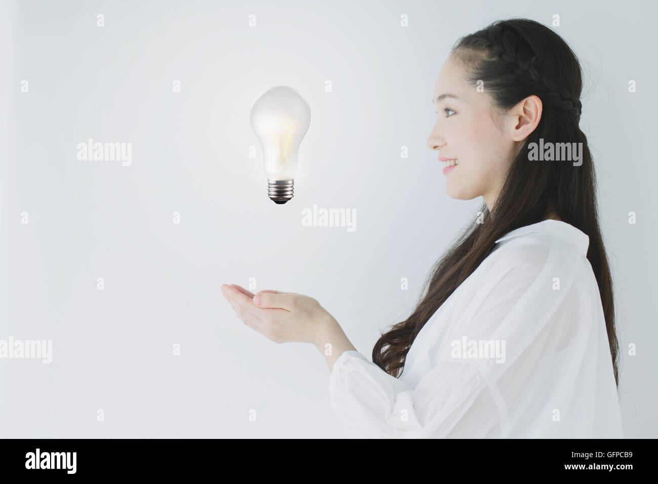 Japanese woman with light bulb Stock Photo - Alamy