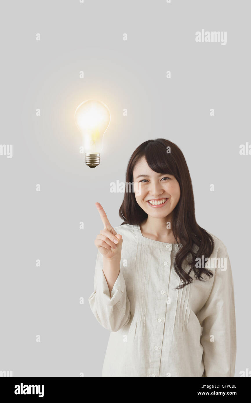 Japanese woman with light bulb Stock Photo - Alamy