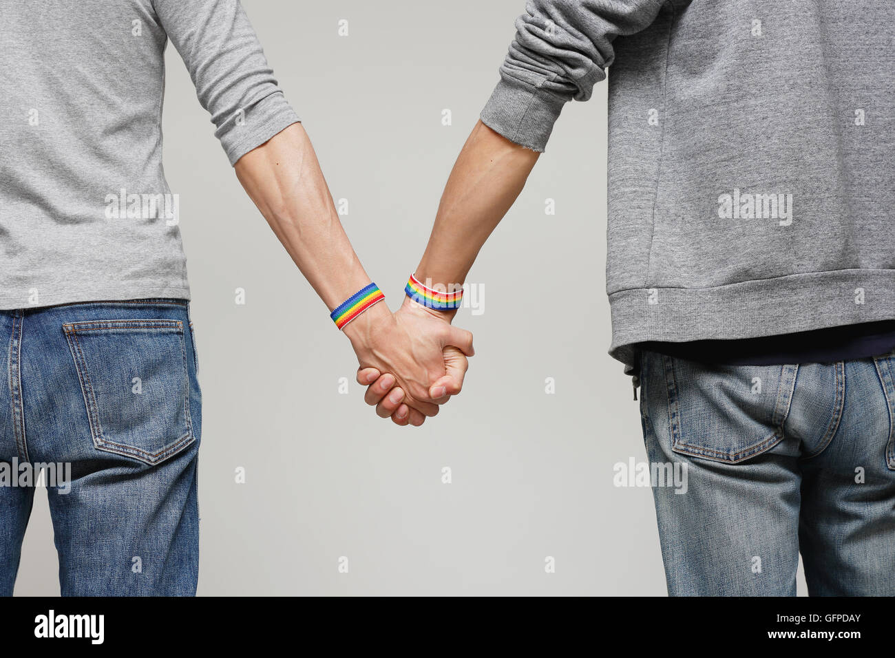 Male couple holding hands Stock Photo - Alamy