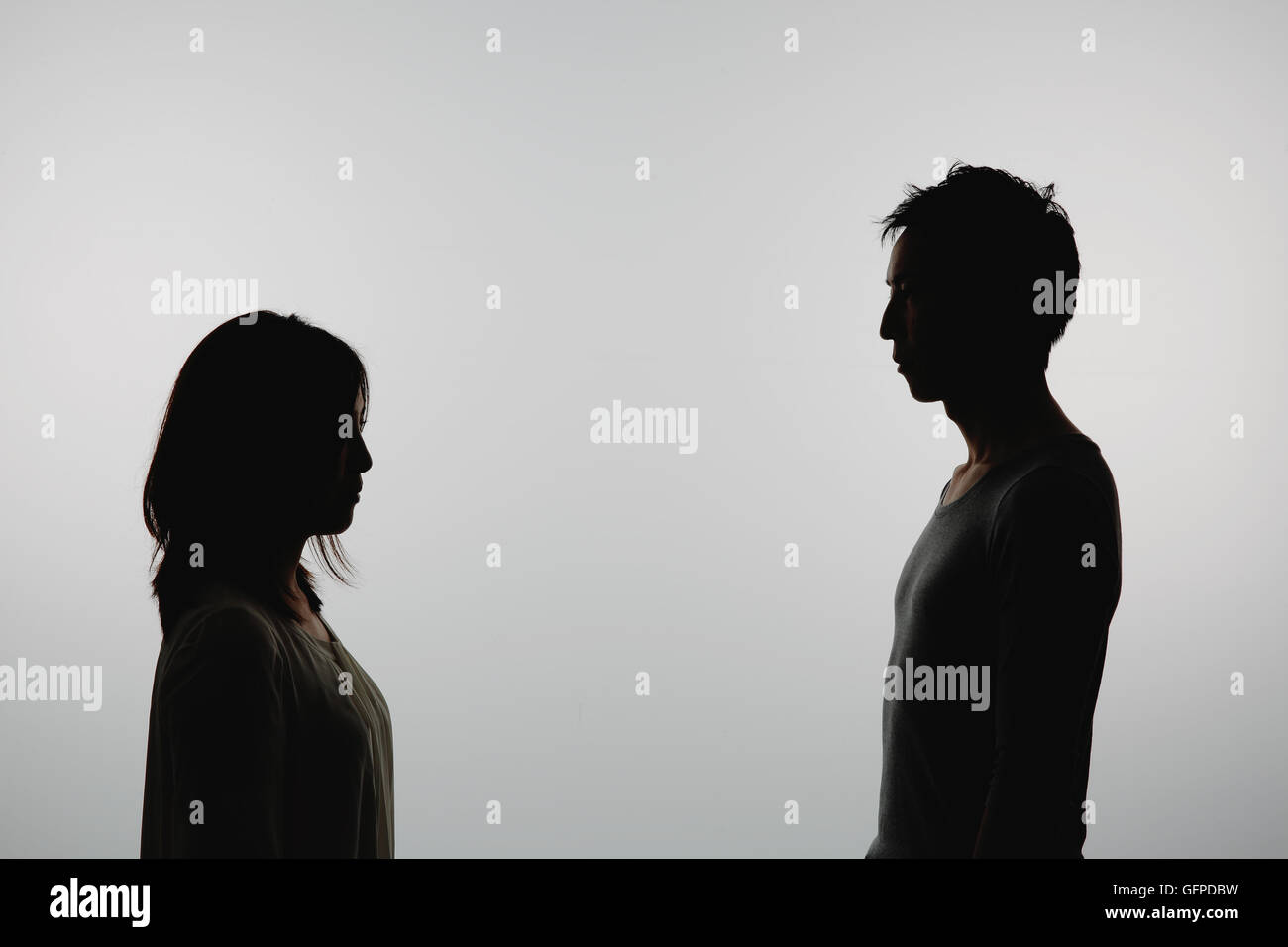 Two silhouette facing each other hi-res stock photography and images ...