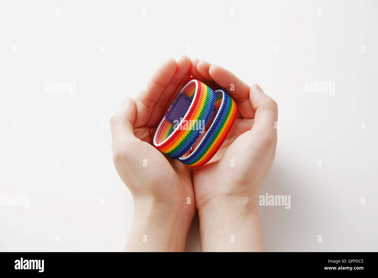 Hands holding rainbow wristbands Stock Photo - Alamy