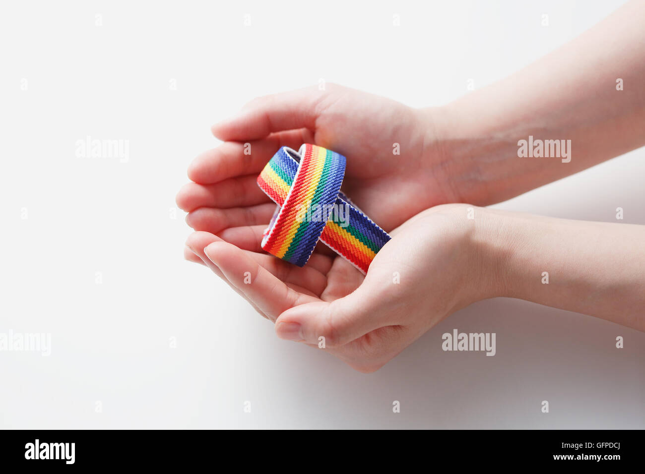 Hands holding rainbow wristbands Stock Photo - Alamy