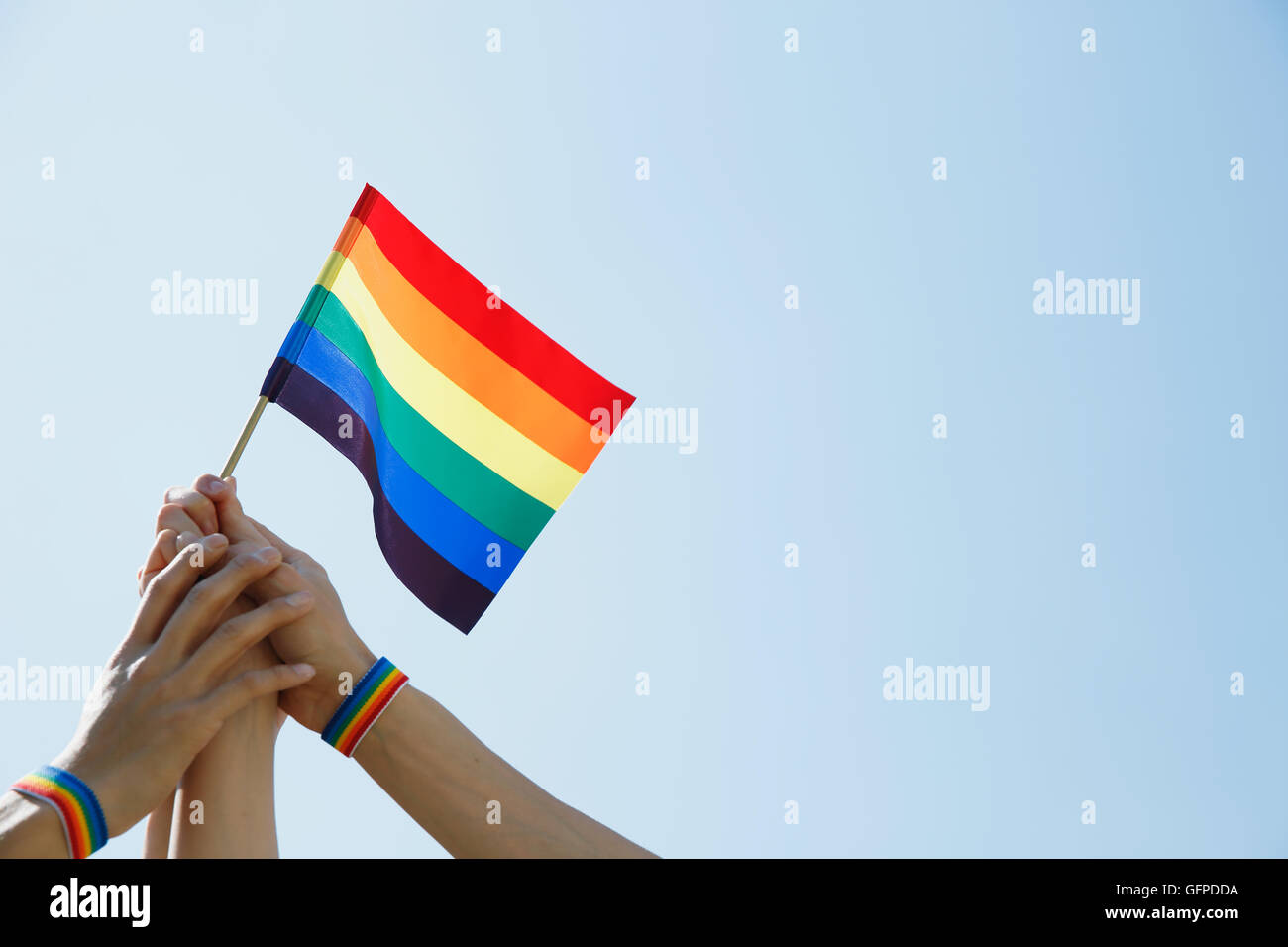 Rainbow flags waving hand hi-res stock photography and images - Alamy
