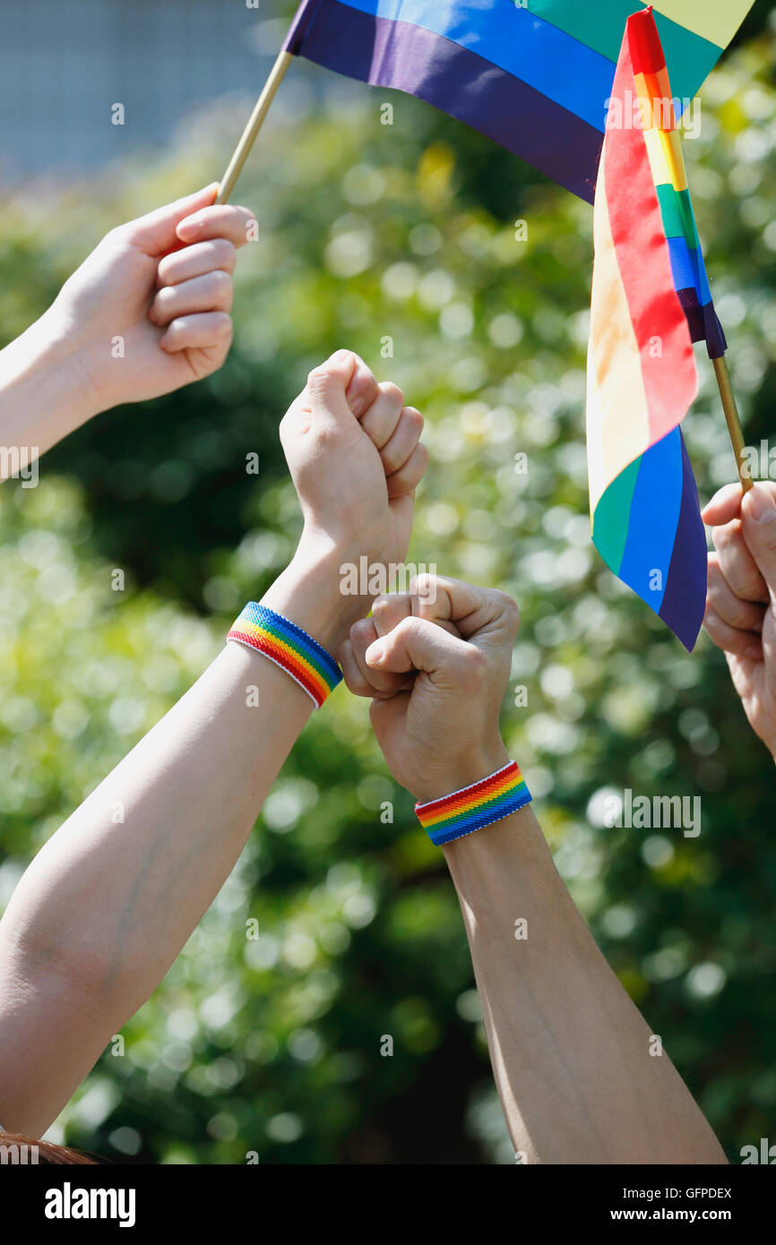Rainbow flags waving hand hi-res stock photography and images - Alamy