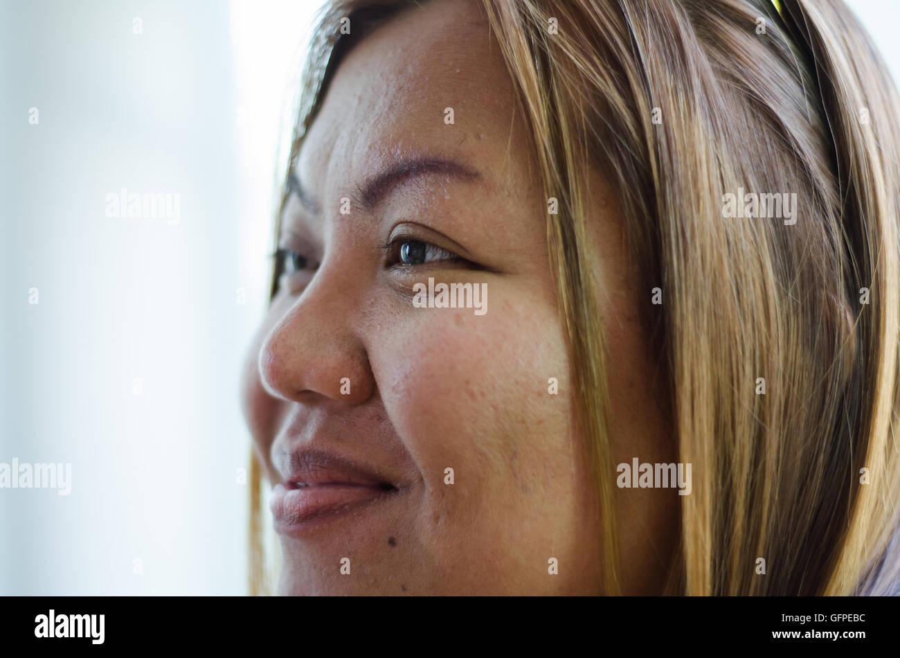A Filipino lady poses for a portrait outside on a balcony Stock Photo ...