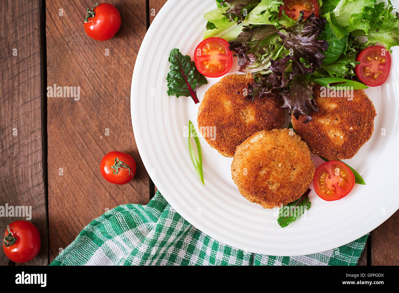 Small chicken cutlet with vegetables on a plate. Top view Stock Photo ...