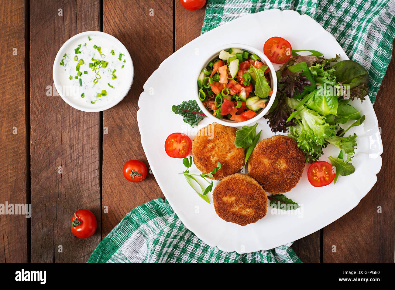 Small chicken cutlet with vegetables on a plate. Top view Stock Photo ...
