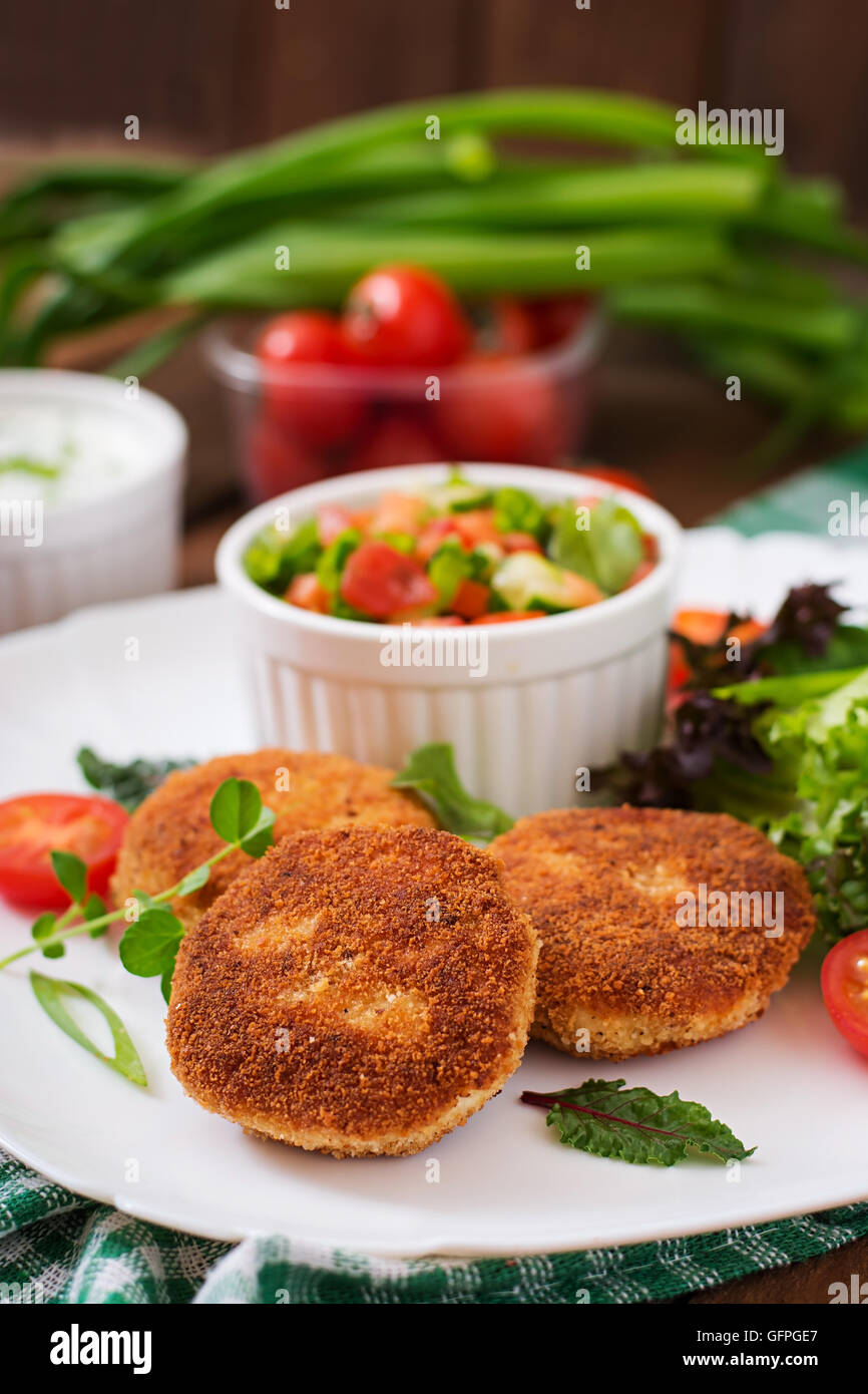Small chicken cutlet with vegetables on a plate Stock Photo - Alamy