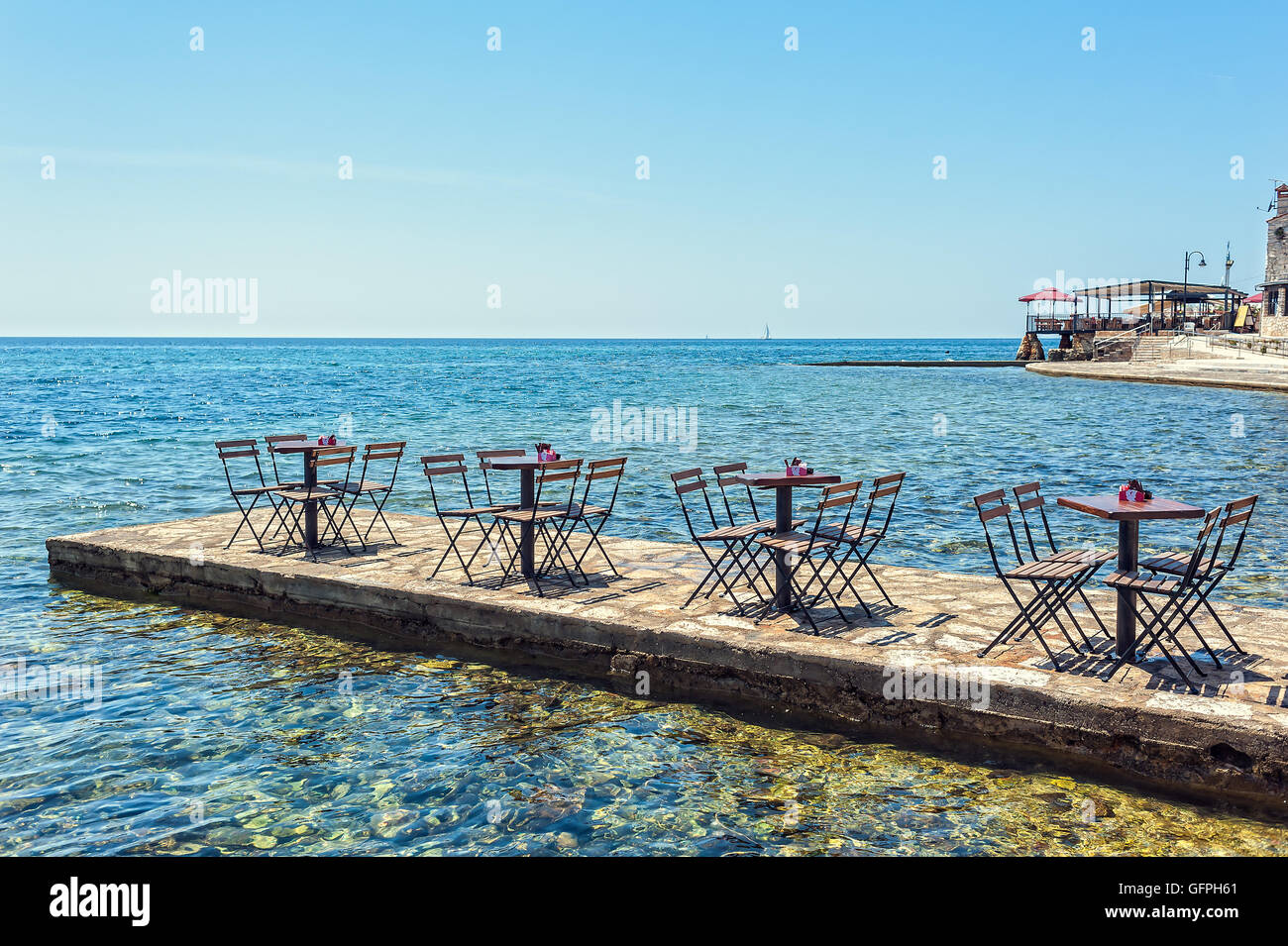 A row of small tables of bars on the pier at sea Stock Photo - Alamy