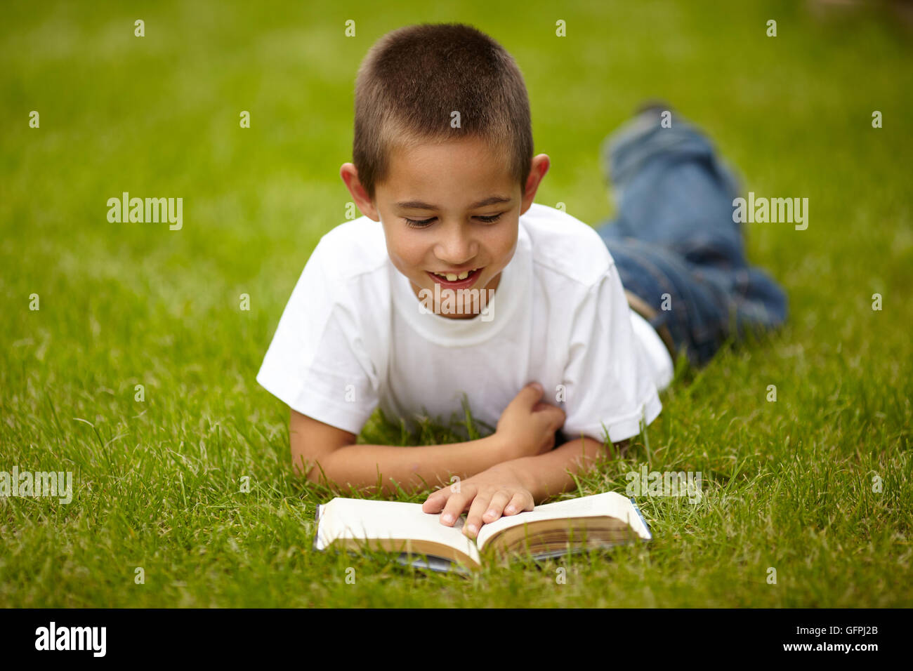 little happy boy reading book Stock Photo - Alamy