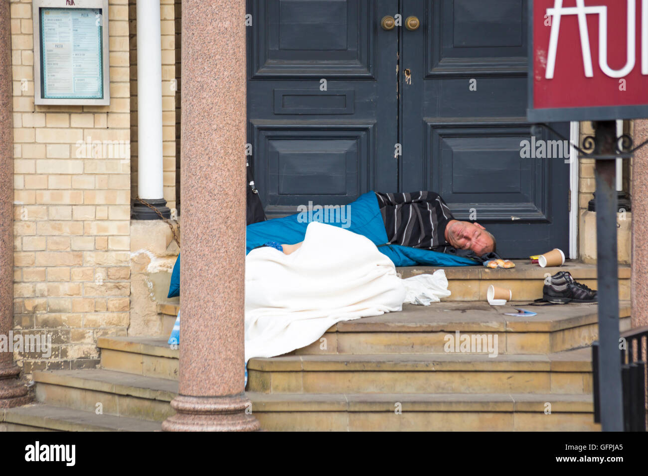 Homeless man sleeping rough in doorway at Bournemouth in July Stock ...