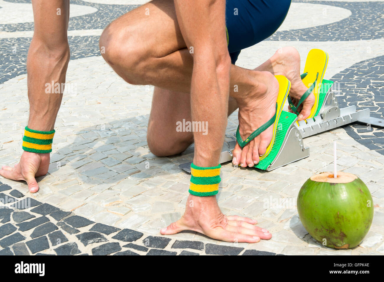 Brazilian athlete wearing flip flops crouching at the start position in ...