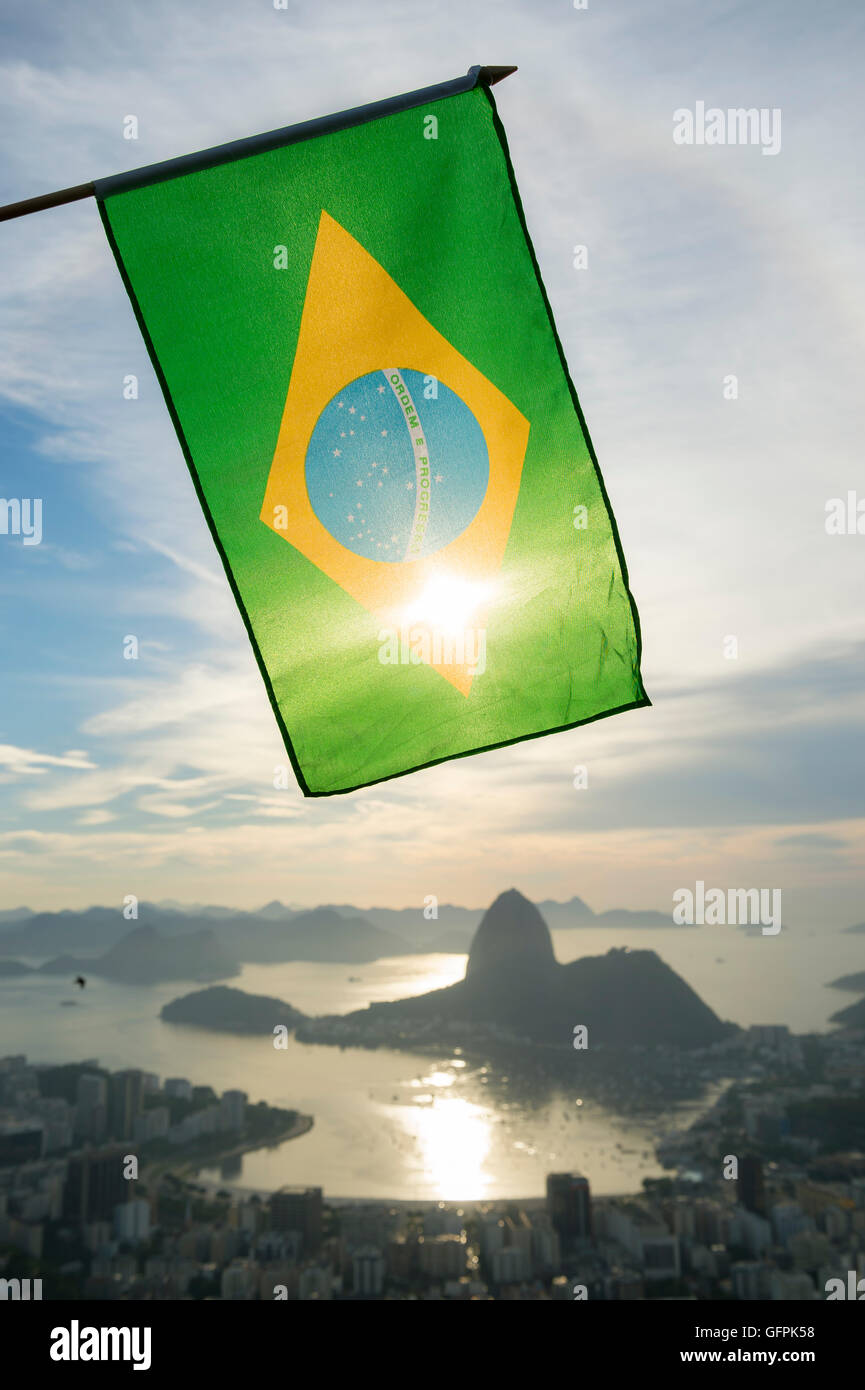 Brazilian flag hanging above the city sunrise skyline view of Sugarloaf ...