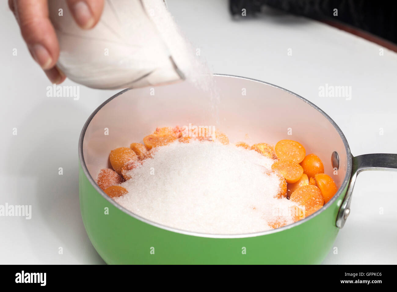 Jam preparation : adding sugar to the fruit Stock Photo - Alamy