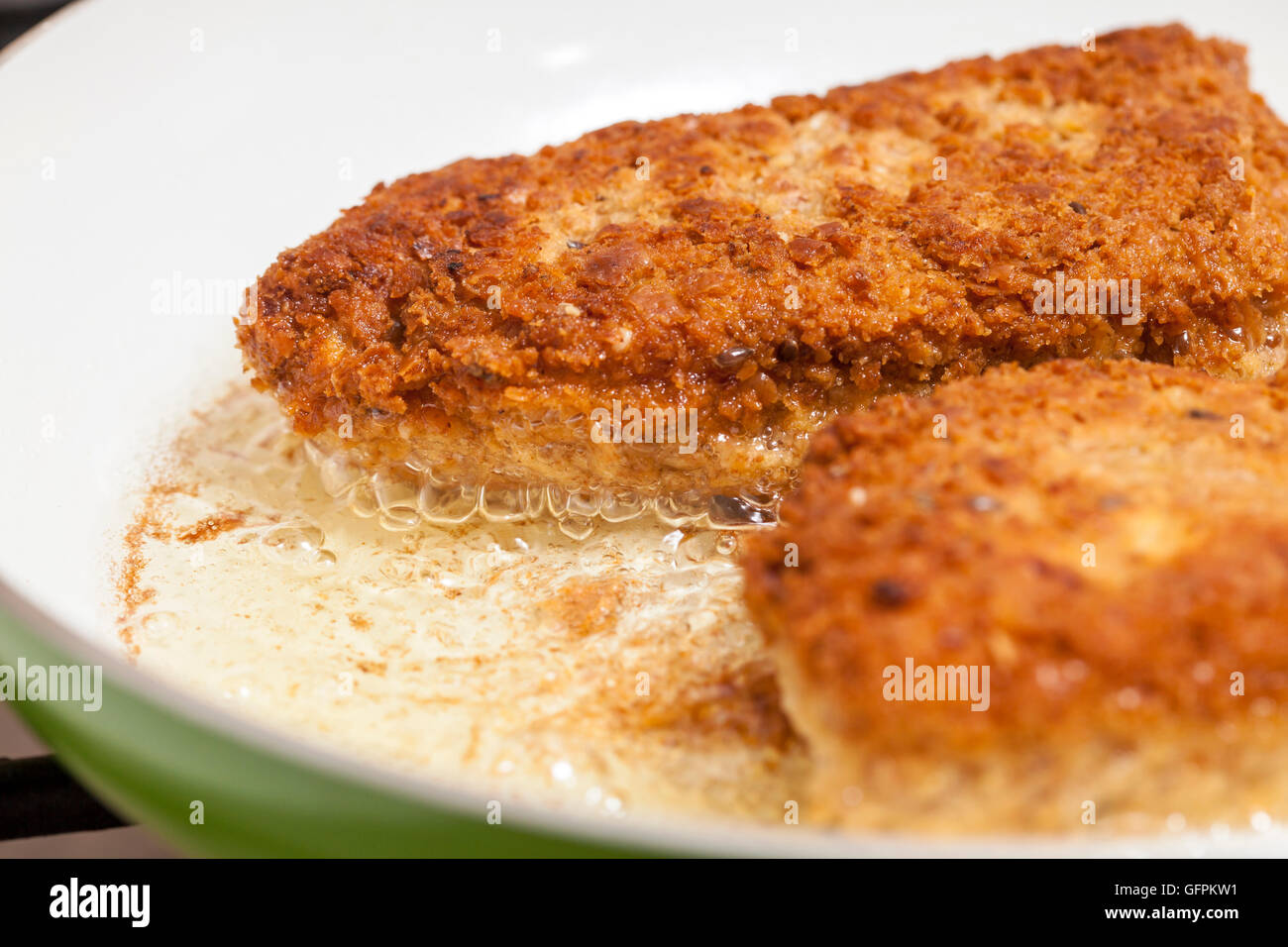 Frying a cordon bleu Stock Photo - Alamy