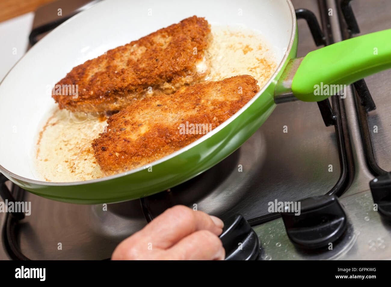 Frying a cordon bleu Stock Photo - Alamy