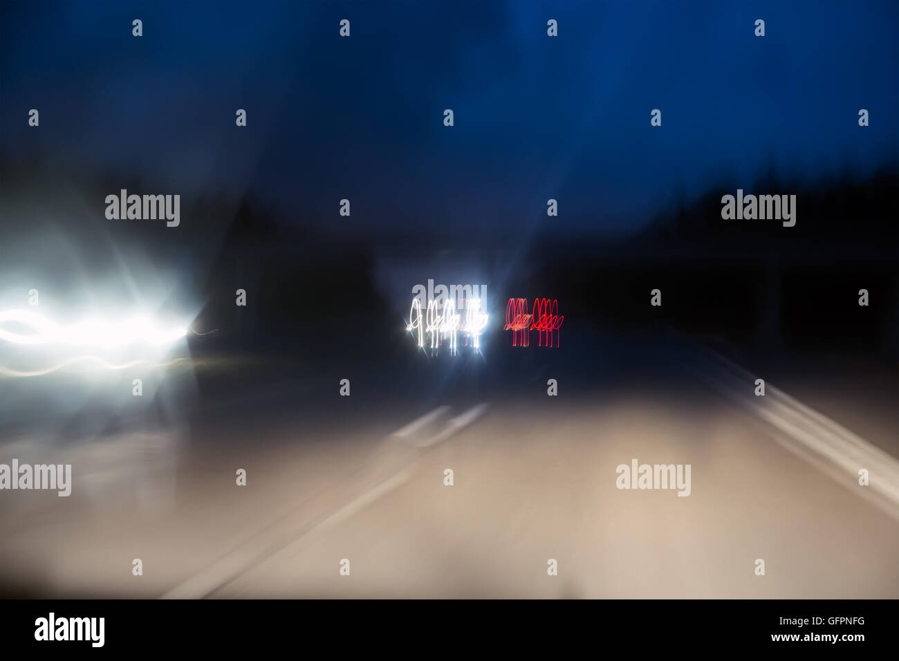 Cars driving in dark oncoming hi-res stock photography and images - Alamy